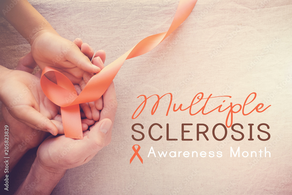 Adult and child hands holding orange Ribbons, Multiple sclerosis ...