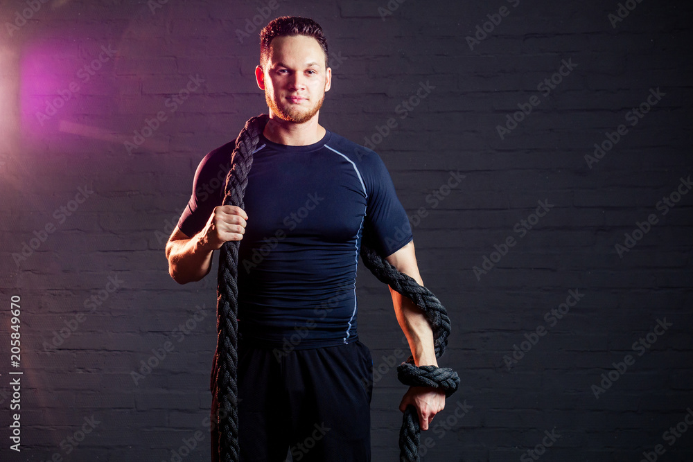 young and handsome male athlete man doing exercises for the muscles of ...