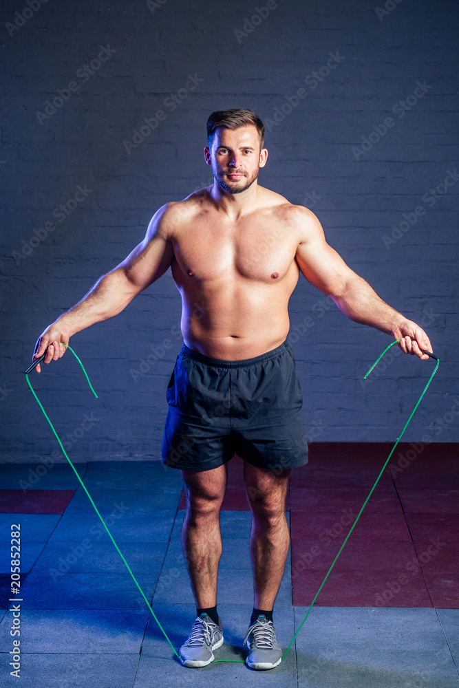 Foto de young and beautiful sportsman male doing exercises for the ...