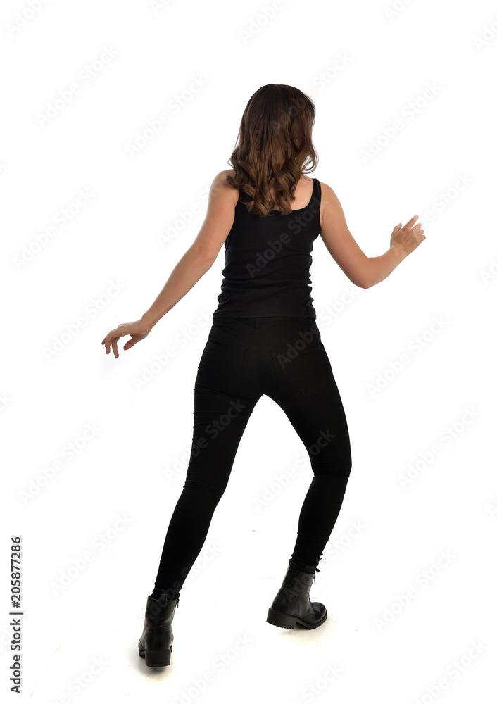 full length portrait of brunette girl wearing black singlet, jeans ...