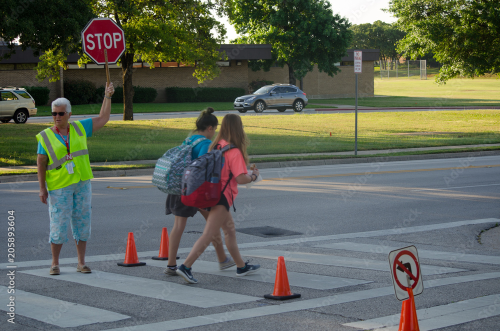 Two Young Girls Going to School at Intersection with School Crossing ...