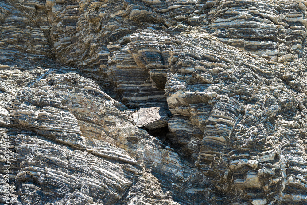 Compressed rock layers formation in various colors and thicknesses, on ...