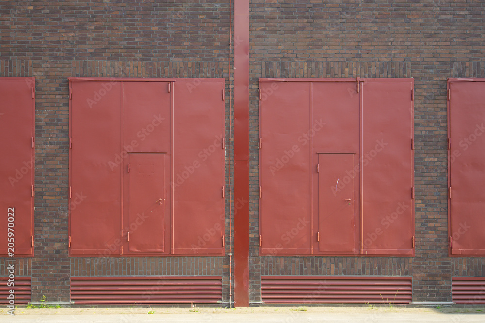 Red painted vintage industrial steel door and brick exterior door of ...