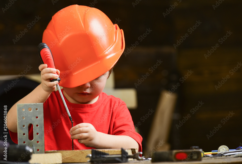Boy play as builder or repairer, work with tools. Childhood concept ...