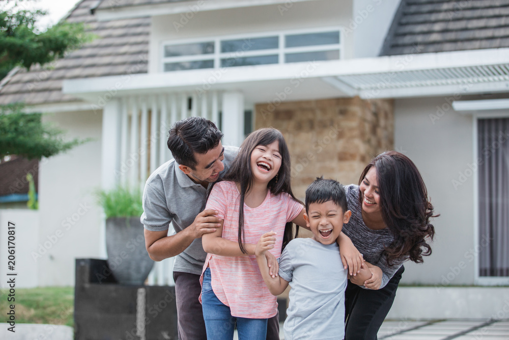 family in front of their new house Stock Photo | Adobe Stock
