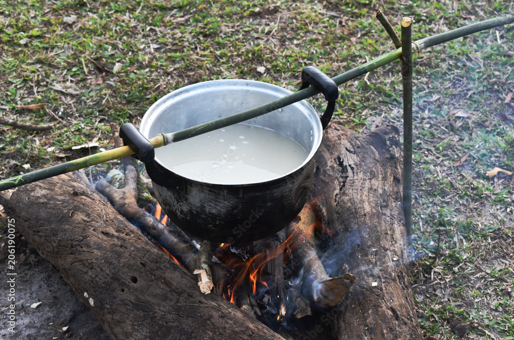 Cooking rice using pot in outdoor nature. Food Camping cooking over a ...