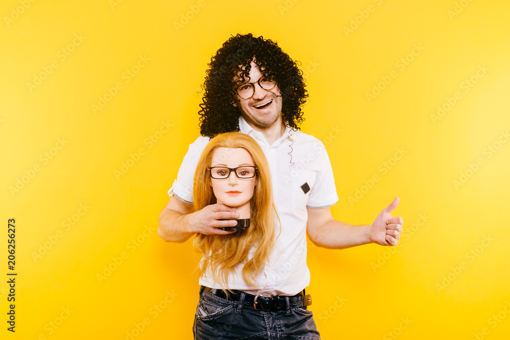 Excited bizarre strange odd foolish guy have fun with plastic mannequin ...