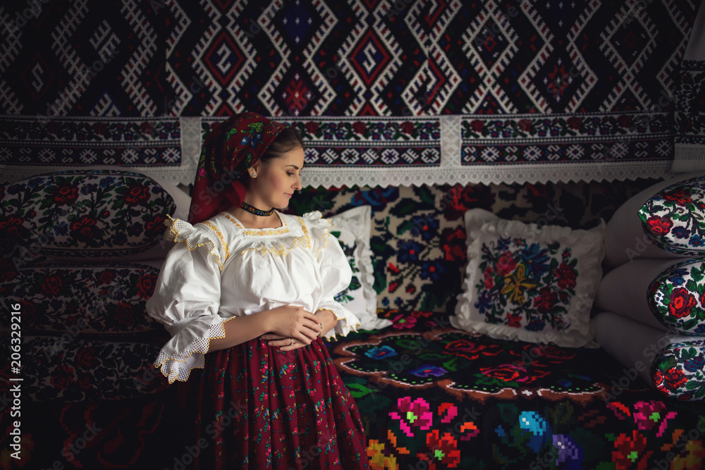 Portrait of a beautiful young woman wearing traditional Romanian ...