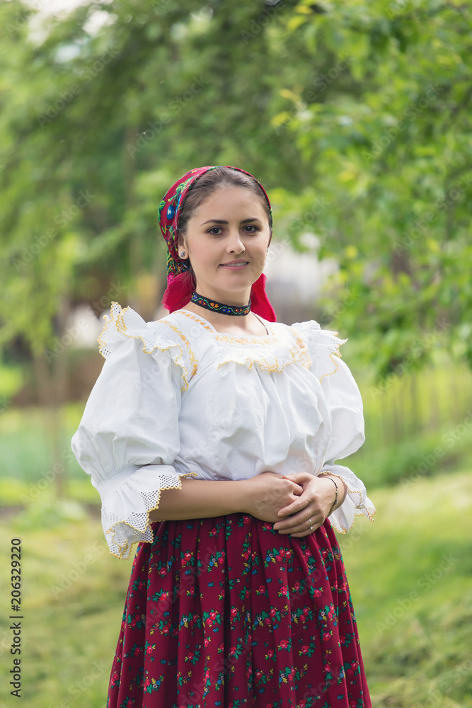 Portrait of a beautiful young woman wearing traditional Romanian ...