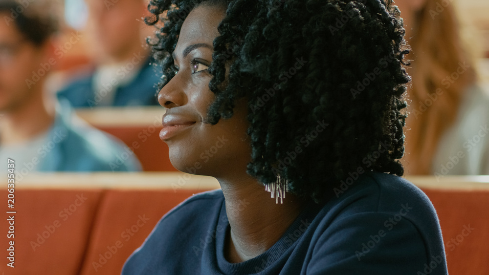 Portrait of a Smart and Beautiful Young Black Girl Listening to a ...