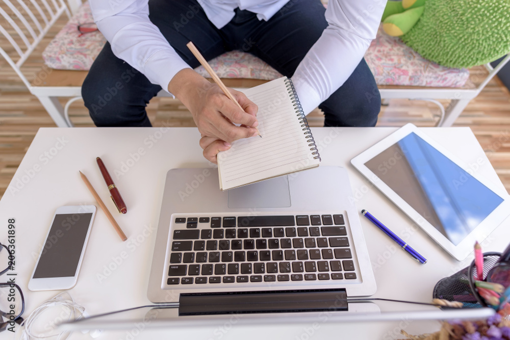 Education technology with Asian male students taking notes on a ...