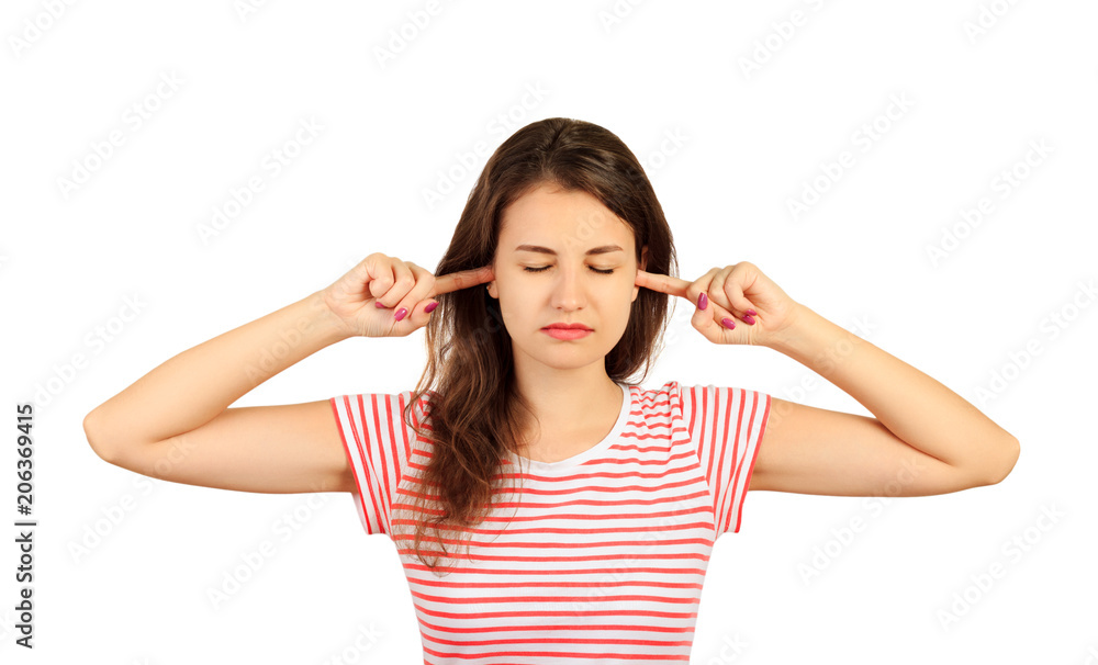young woman plugging ears with fingers and closing eyes tight ...