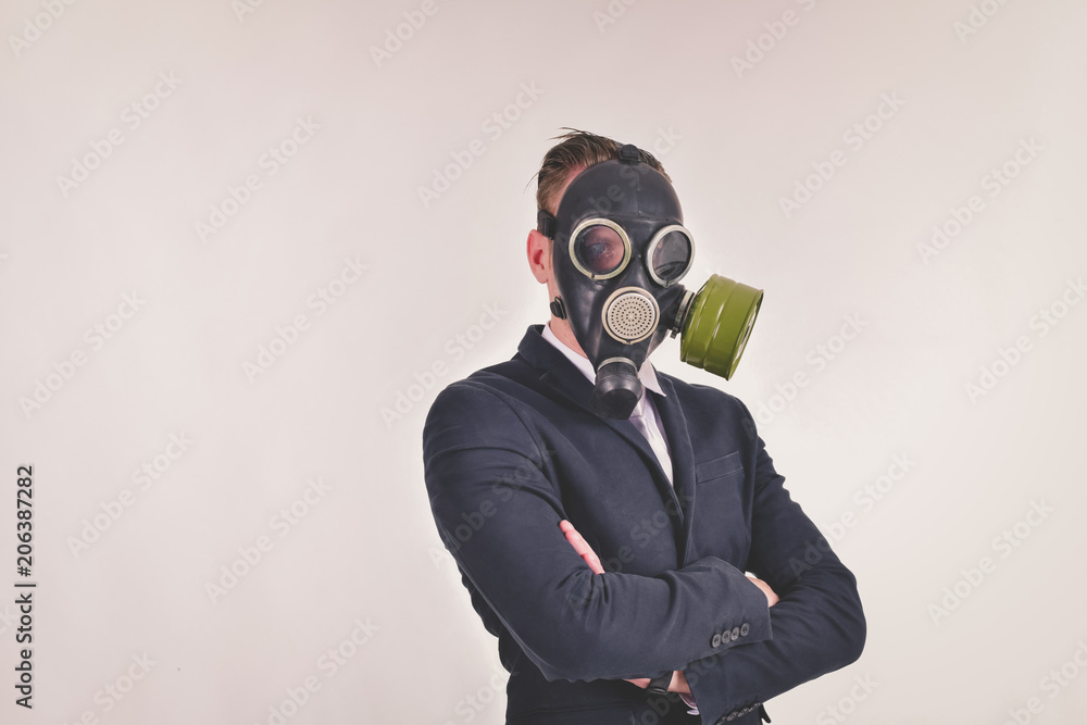 Business Concepts. Businessman wearing a gas mask on a white background ...