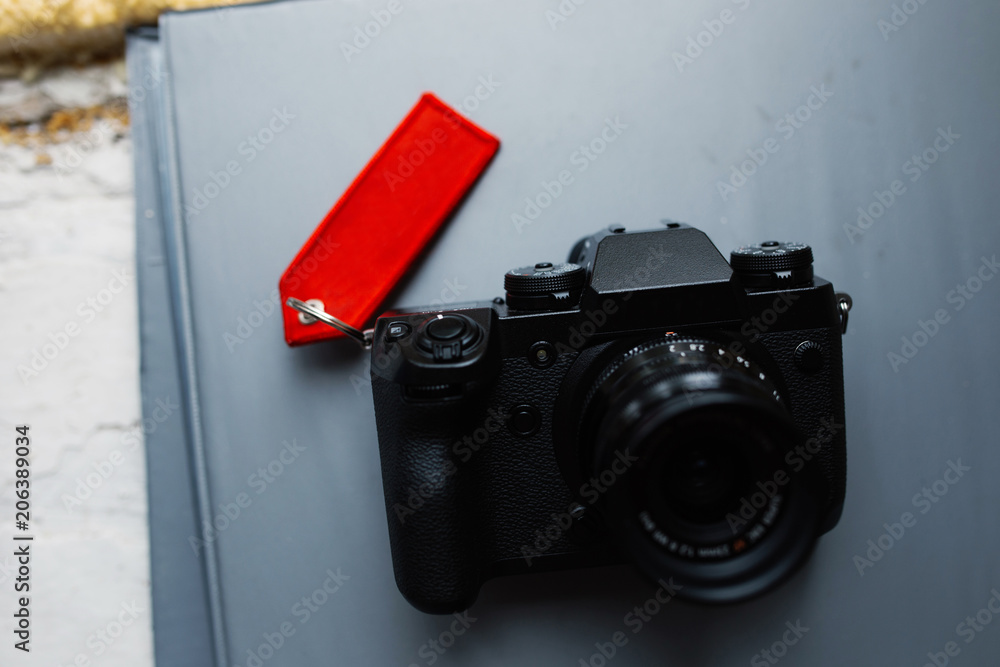 modern photo camera with a portrait lens lies on the windowsill. top ...