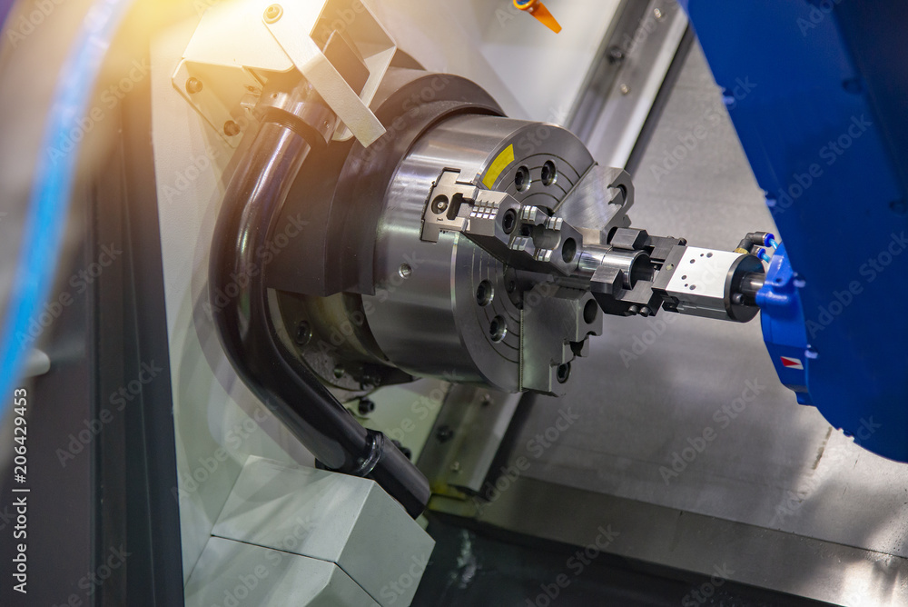 The CNC lathe or turning machine use the robot arm setting the work ...