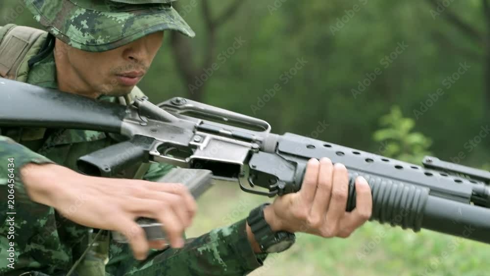 Soldier reloading his weapon. Chinese soldier reloading his assault ...