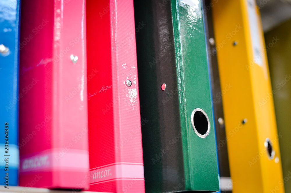 Close up on multicolored office folders on the bookshelf backgrounds ...