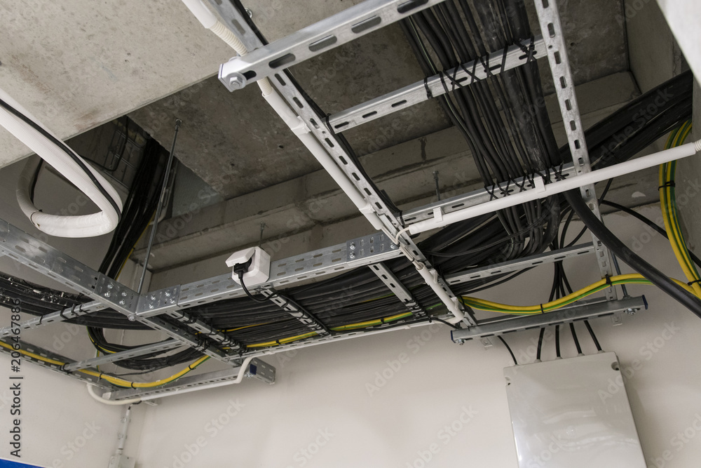 Wired wall socket on the cable tray. Stock Photo | Adobe Stock