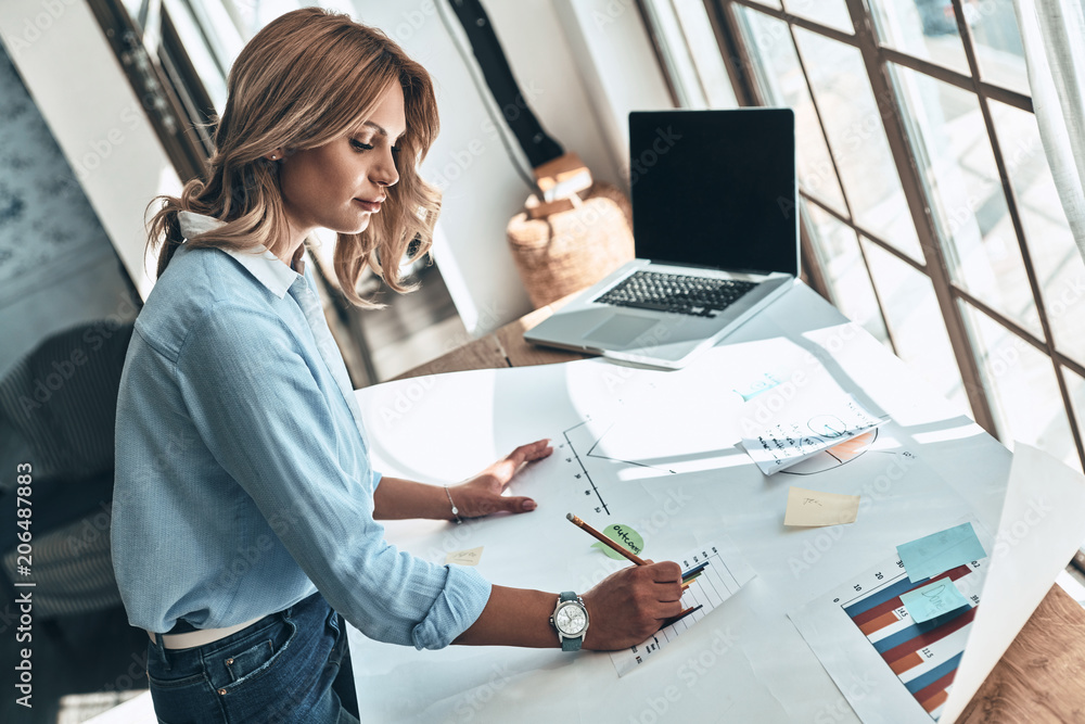 Studying a chart. Stock Photo | Adobe Stock