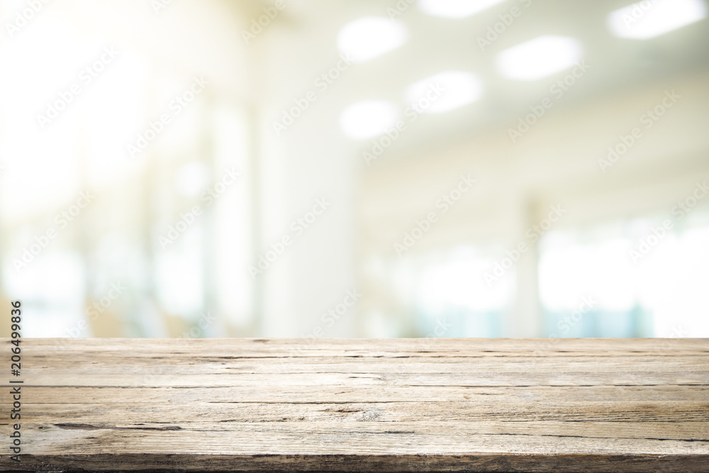 Wooden table with blur background of office room. Photos | Adobe Stock