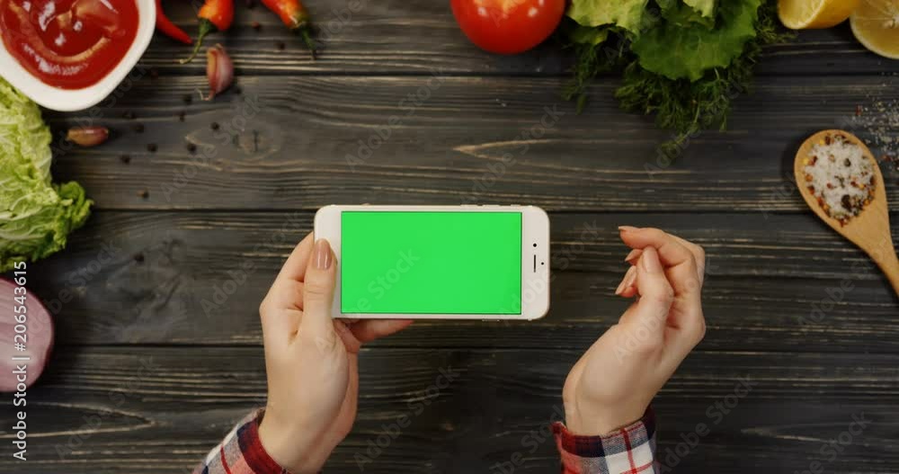 View from above on the white horizontal smart phone on the dark wooden ...