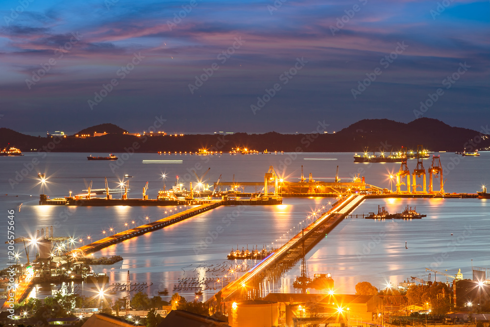 the sea port terminal at sunset in operation loading and discharging ...