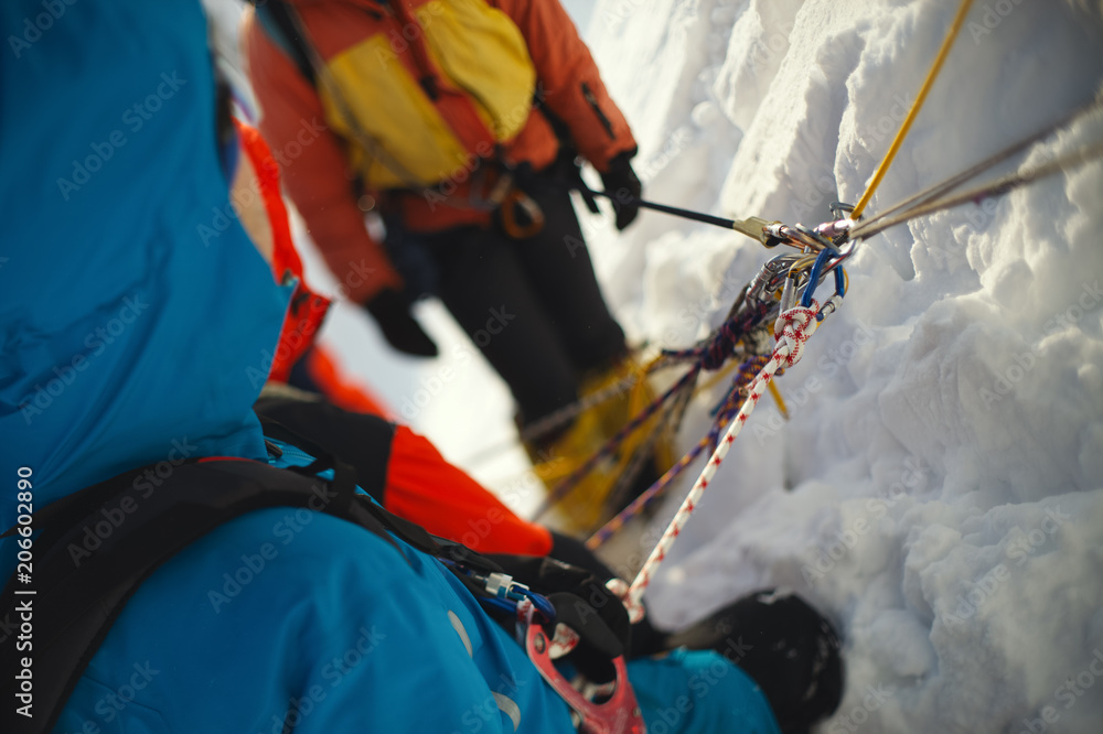 Fall protection mount climbers on the mountain slope, close-up. Tilt ...