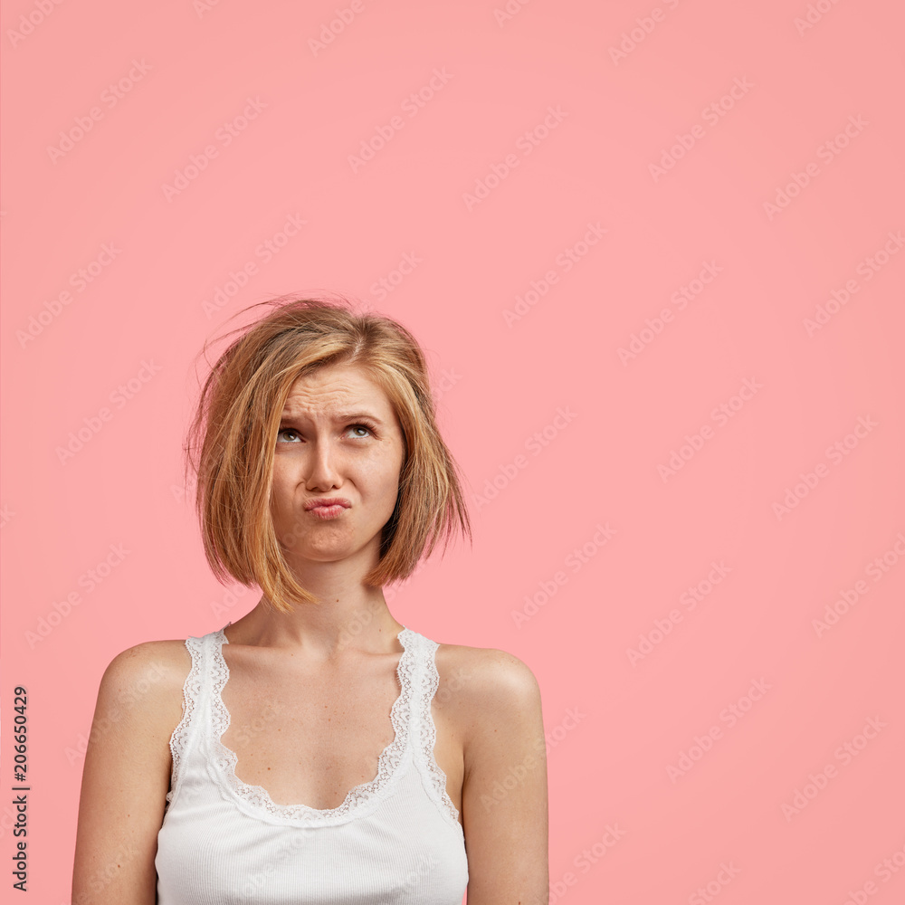 Zdjęcie Stock: Perplexed attractive female frowns face, has gloomy ...