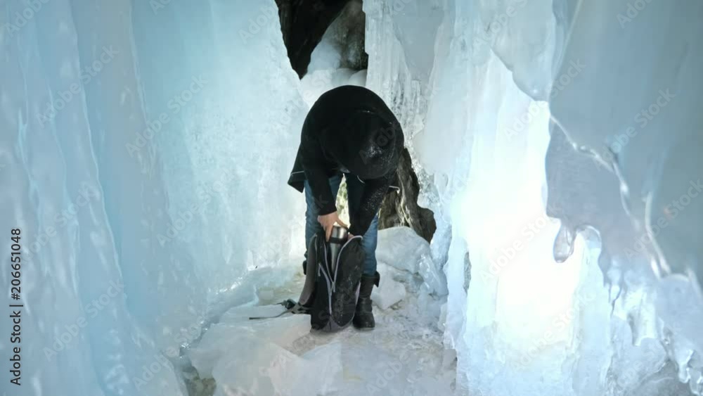 Hacker hacks the server. Man to program on laptop in ice cave. Around ...