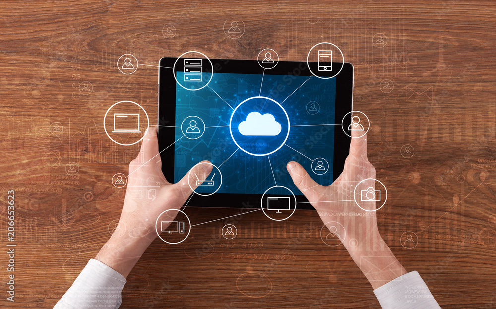 Hand touching tablet with cloud computing and online storage concept ...