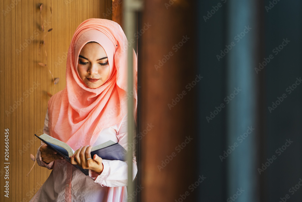 Beautiful Muslim girl reading book with hijab Stock Photo | Adobe Stock