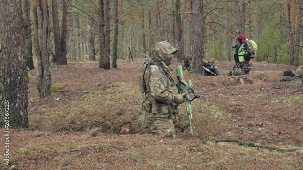 Soldiers in camouflage with combat weapons are being fired in the ...
