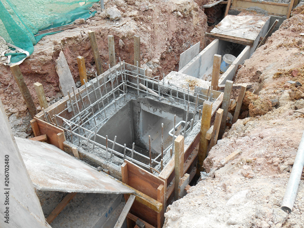 Underground drainage manhole under construction by construction workers ...