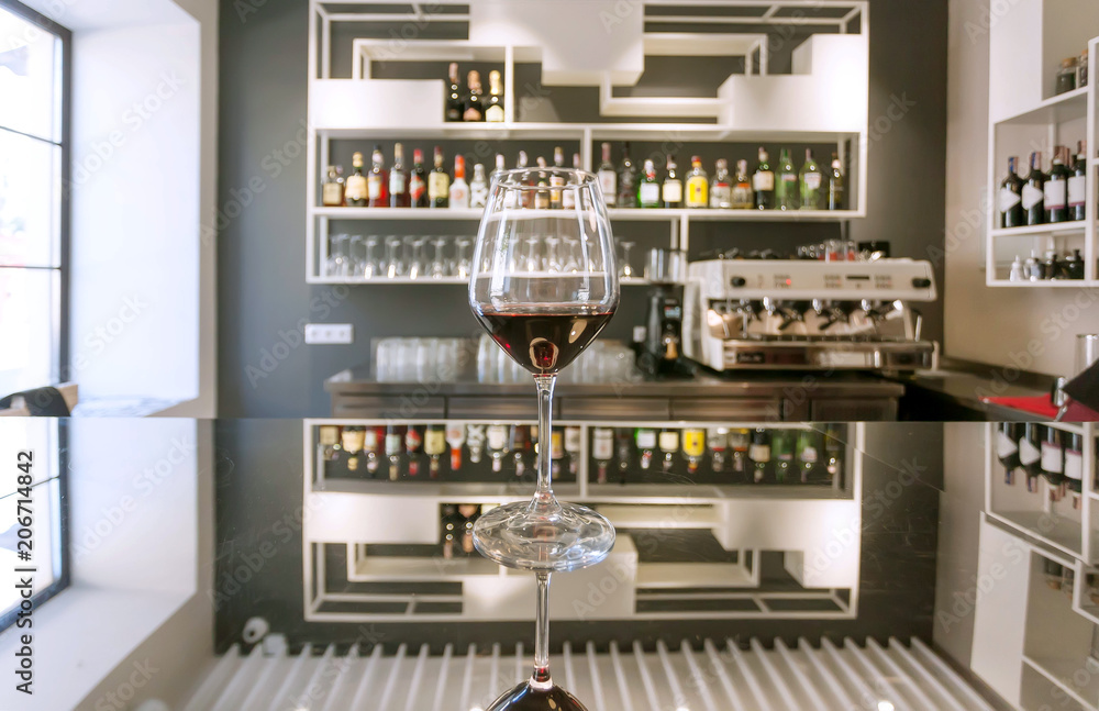 Wine glass on bar counter with reflections at contemporary design style ...