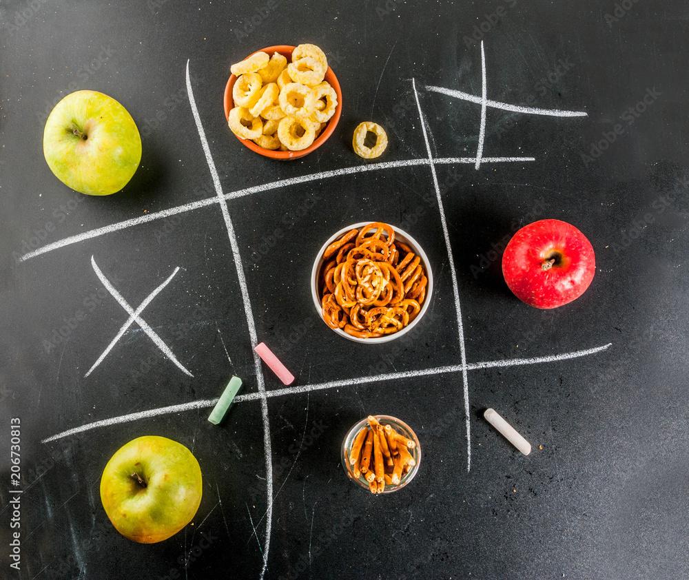 Tic tac toe healthy and unhealthy snack concept with crackers, chips ...