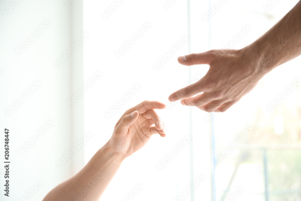 Man and woman reaching out to one another on light background. Unity ...