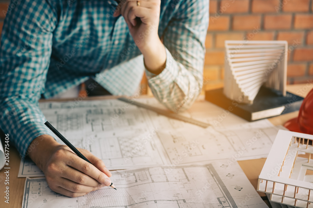 Architect man looking blueprint on desk with stress about problem ...