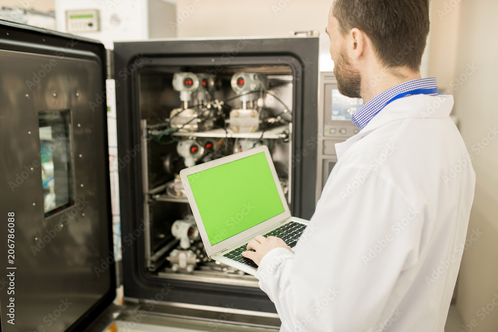 Busy professional male engineer in lab coat adjusting pressure ...