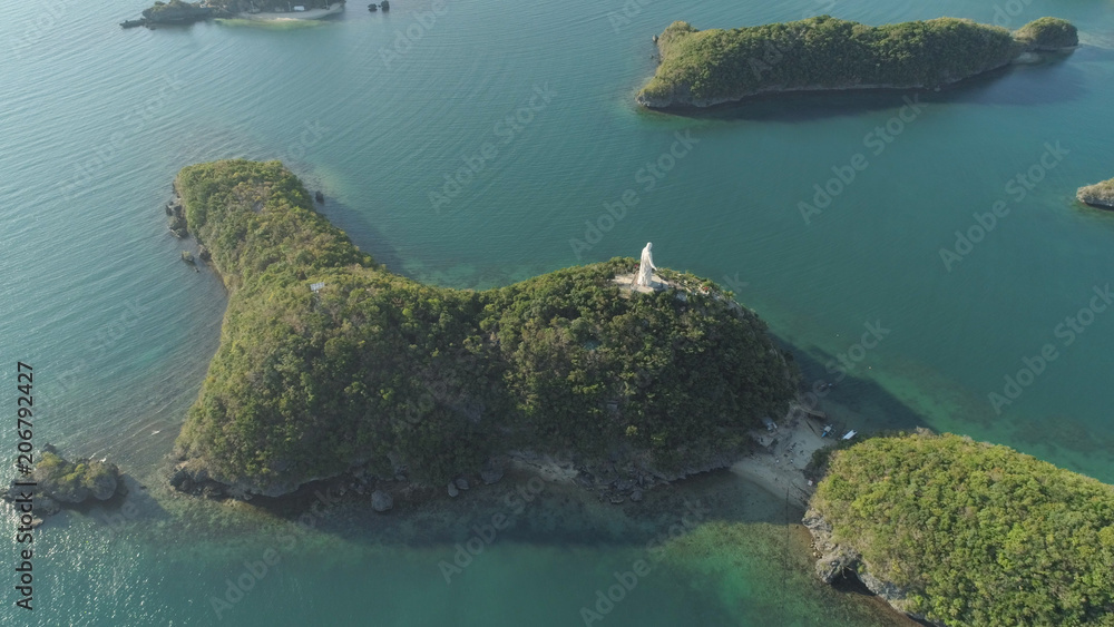 Small islands in Hundred Islands National Park with statue of Jesus ...