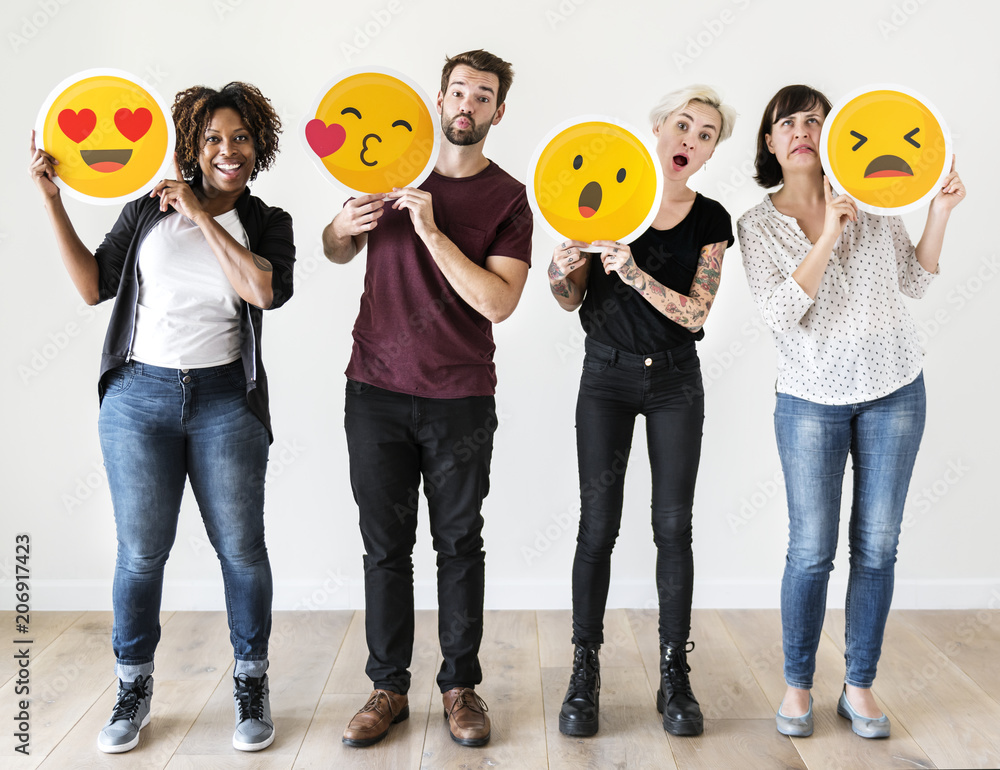 Diverse people holding emoticon Stock Photo | Adobe Stock