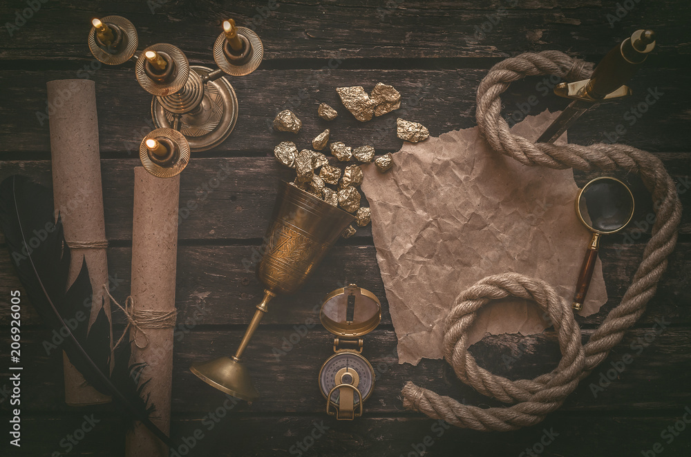 Pirate goblet full of gold and treasure map crumpled parchment with ...