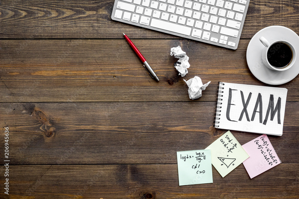 Preparing for the exam. Word Exam written in notebook on student's desk ...