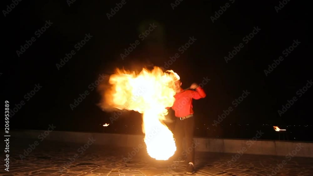 Vidéo Stock Artist man rotates the fireball.Man twist fiery circles on ...