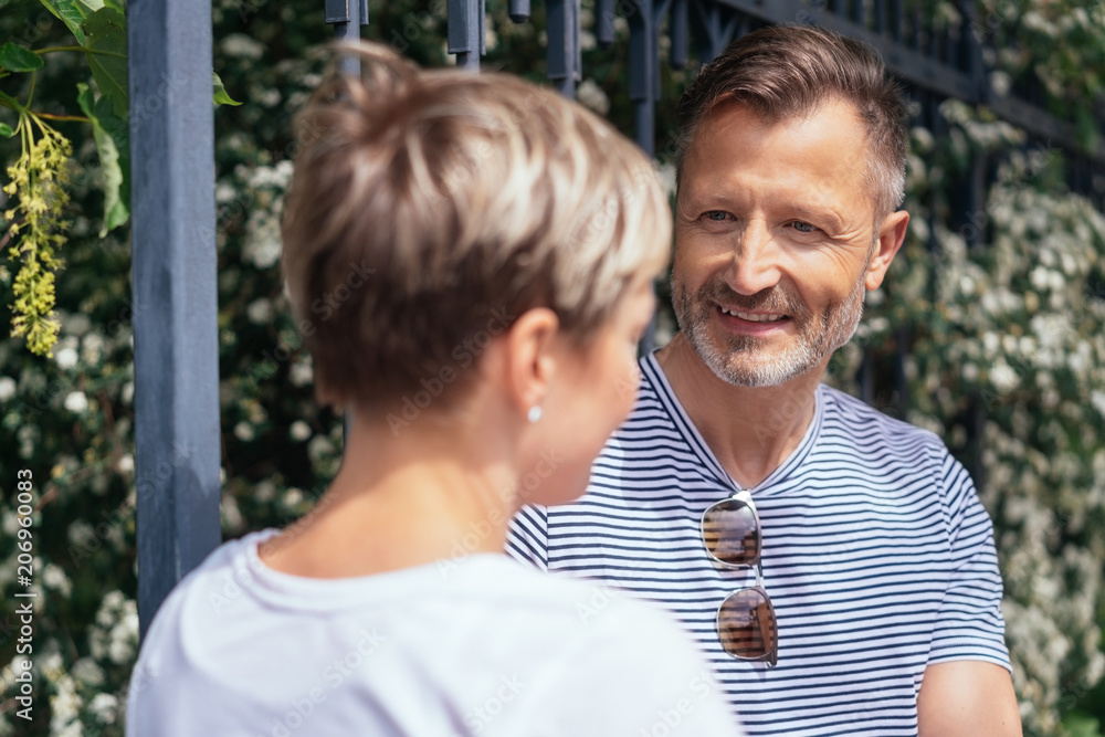 Middle-aged man and woman chatting outdoors Stock-Foto | Adobe Stock