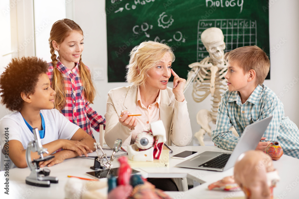 Visual representation. Pleasant nice woman pointing at her eye while ...