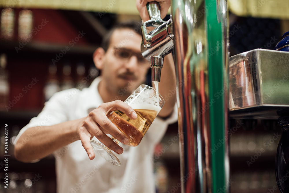 waiter pulling a beer in a pub Stock Photo | Adobe Stock