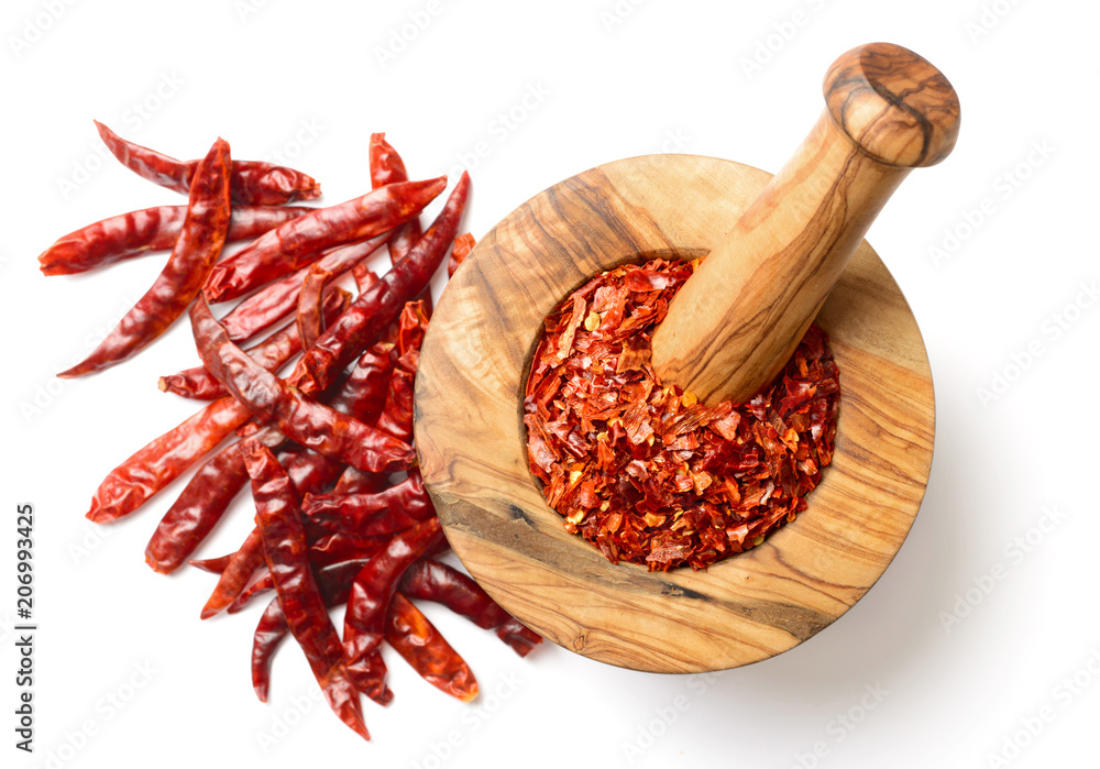 dried red pepper flakes in the wooden mortar, isolated on white, top ...