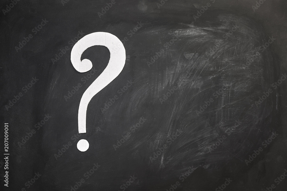 question mark made of cardboard on chalkboard background with copy ...