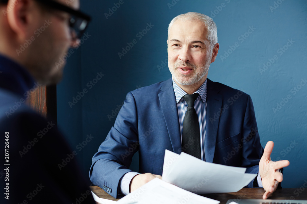 Mature businessman having an interview with man. He is communicating ...
