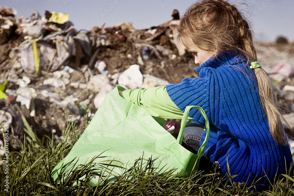 Poor child in the landfill is digging in the garbage Stock Photo ...